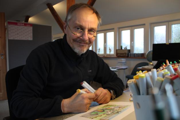 Comiclesung in Schuby: Cartoonust Kim Schmidt spricht über Grenze